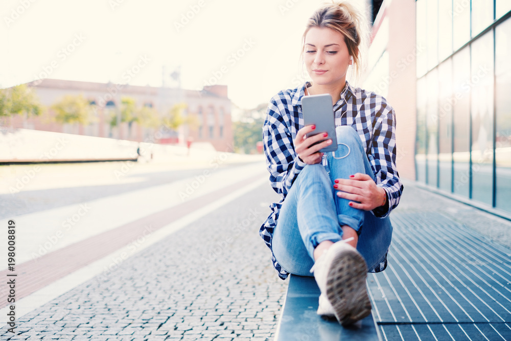Girl watching her smartphone display in urban context Stock Photo ...