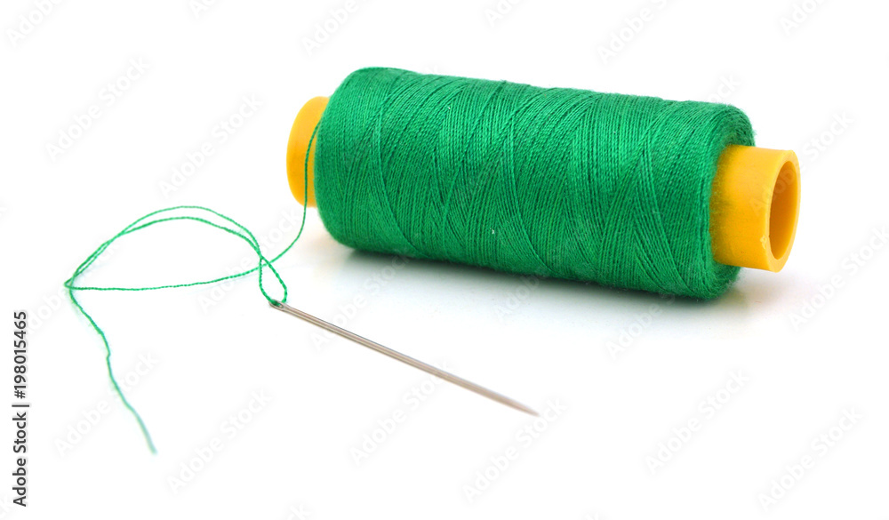 Spool of green thread and needle isolated on white background Stock ...