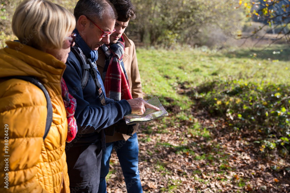 Family looking at map during nature hike Stock Photo | Adobe Stock