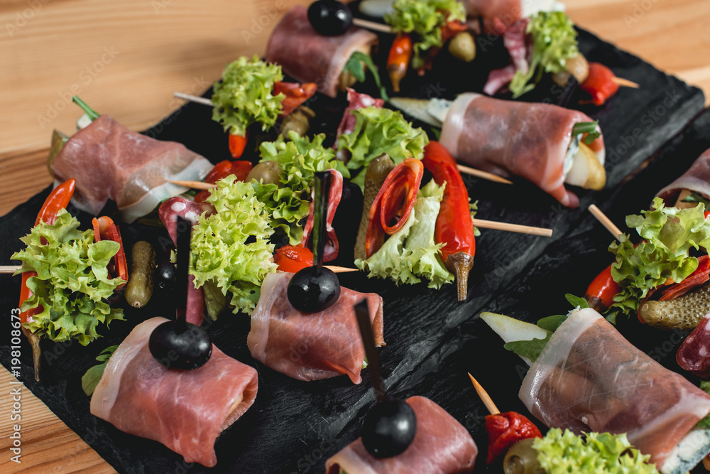 spanish snack, banderillas on skewers with jamon, ramses, pear, dorblue ...