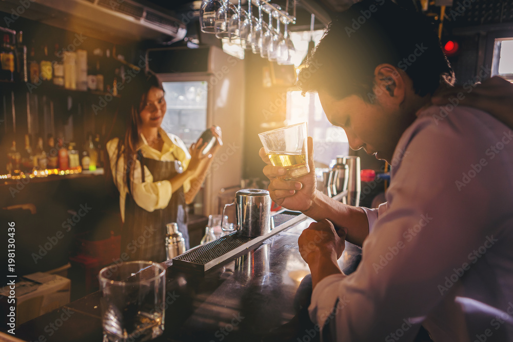 Female bartender are serving alcohol to depressed drink customers at ...