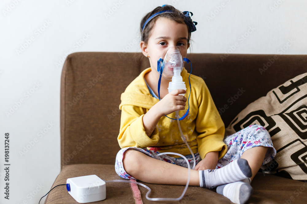 Little girl making inhalation with nebulizer at home child asthma ...