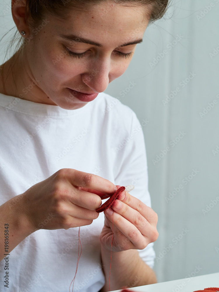 Step-by-step process of manual manufacturing baby crib mobile. Sewing a ...