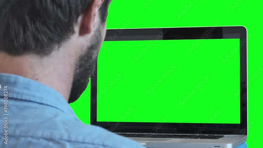 Laptop Green Screen Man On Computer. Man using a laptop computer on a ...