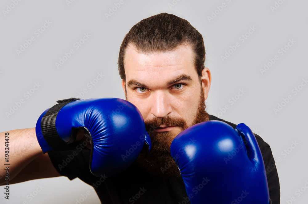 The man in boxing gloves. Young Boxer fighter over black background ...