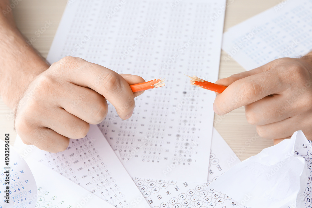 Nervous student breaking pencil while passing exam, closeup Stock Photo ...