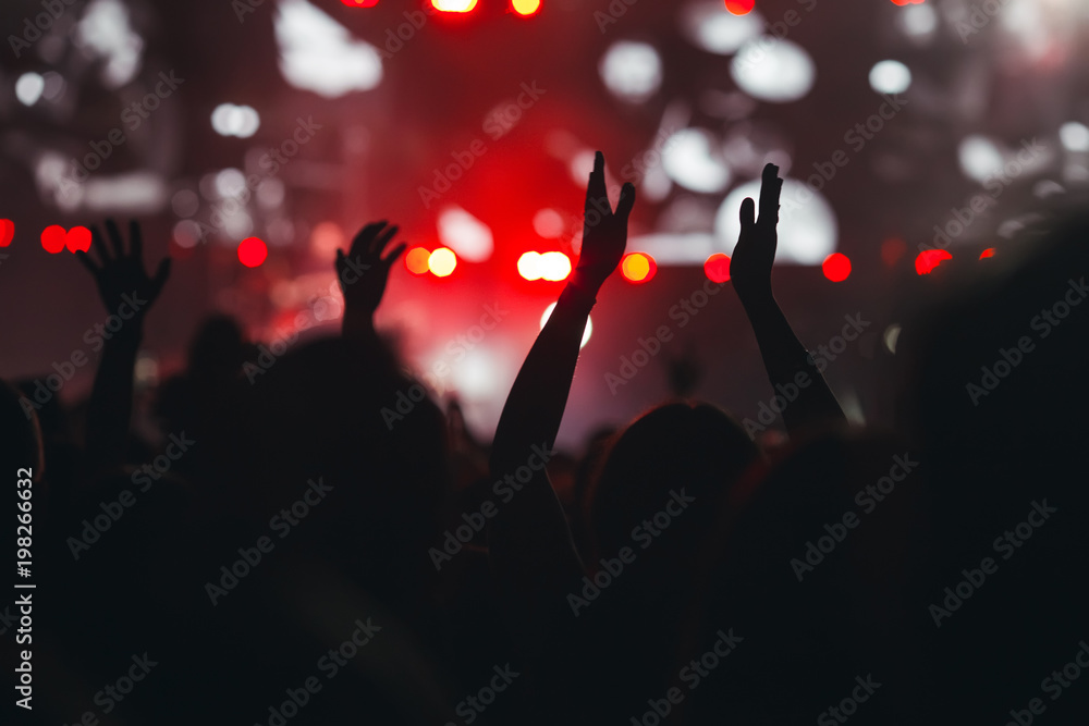 Crowd of people silhouettes with their hands up at music festival, rock ...