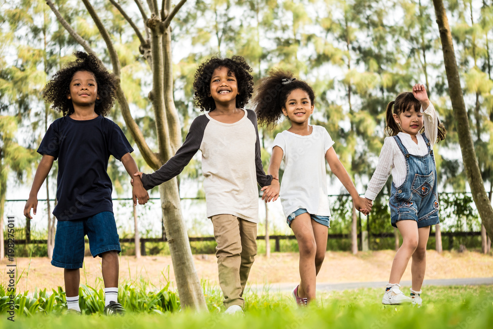 Group of children having fun playing together. Kids holding hands and ...