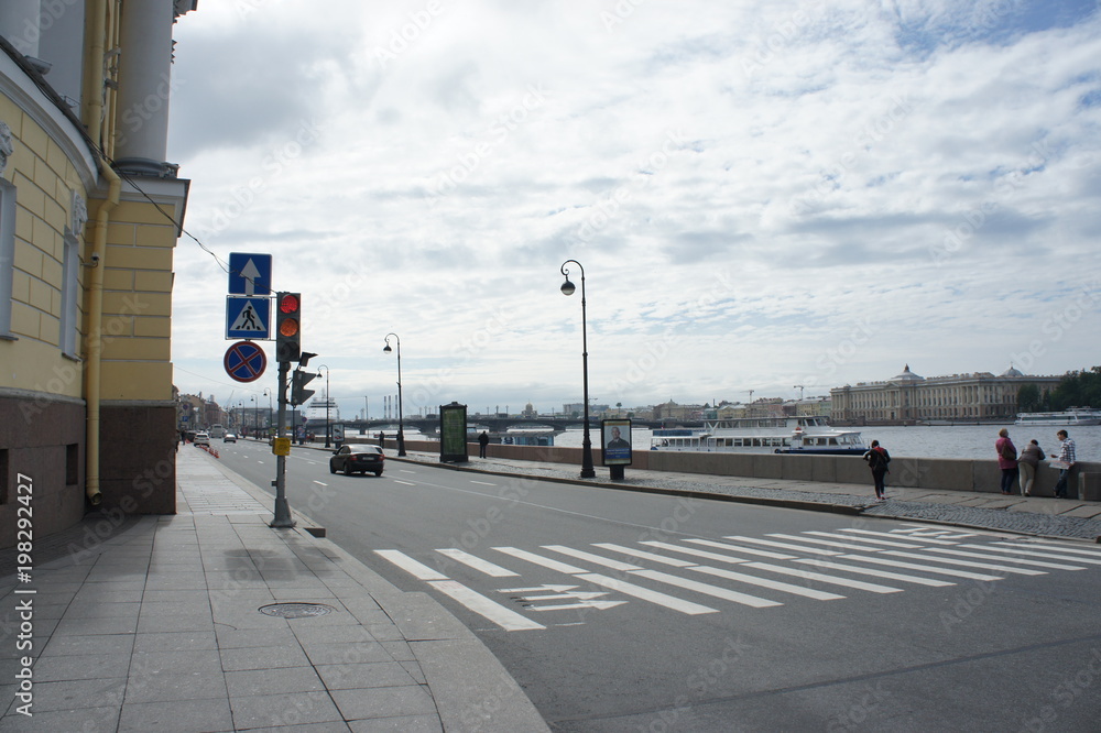 Foto de Road with cars, pedestrian crossing, road signs along the ...