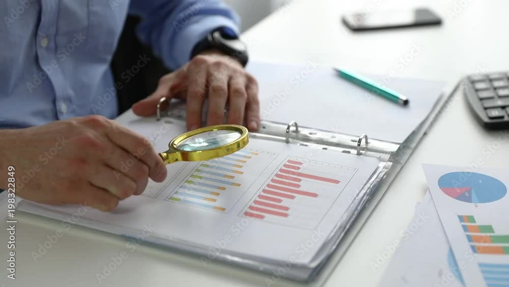 internal audit concept - auditor with magnifying glass inspecting ...