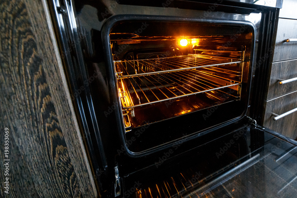 Empty open electric oven with hot air ventilation. New oven. Door is ...