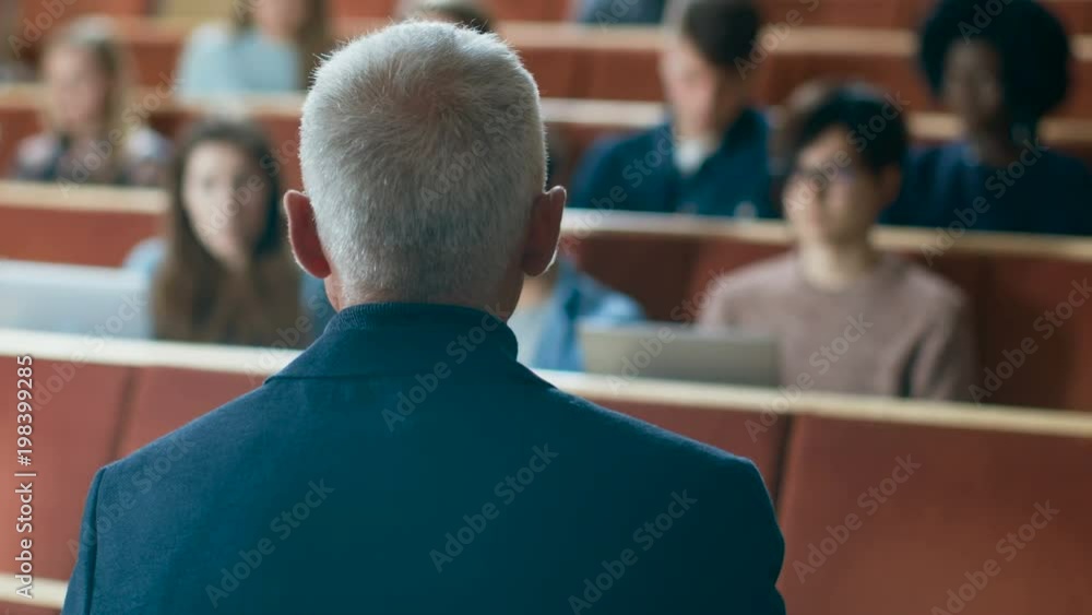 Camera Facing Class: College Professor Gives a Lecture to a Classroom ...