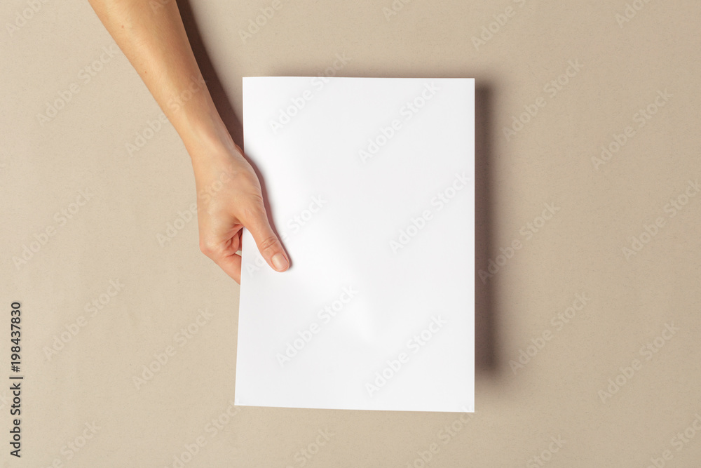 Hand holding papers a4 size Stock Photo | Adobe Stock