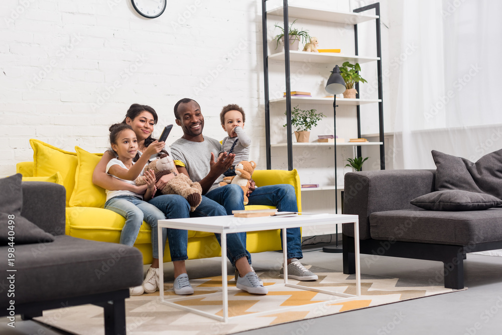 happy young family watching tv together at living room Stock Photo ...