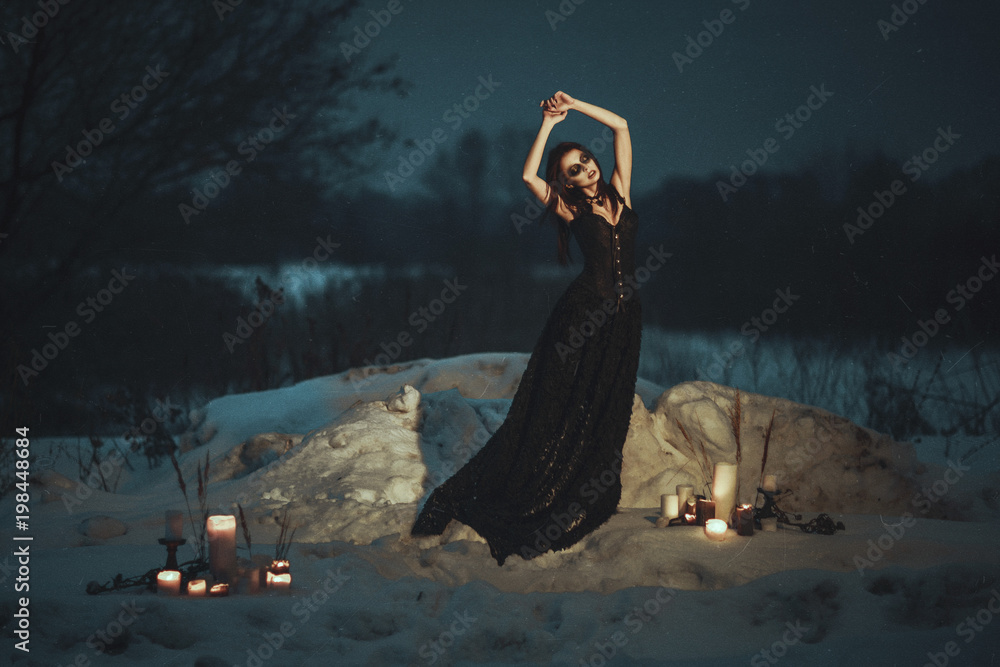 Beautiful model wearing black dress is posing on a snow Stock Photo ...