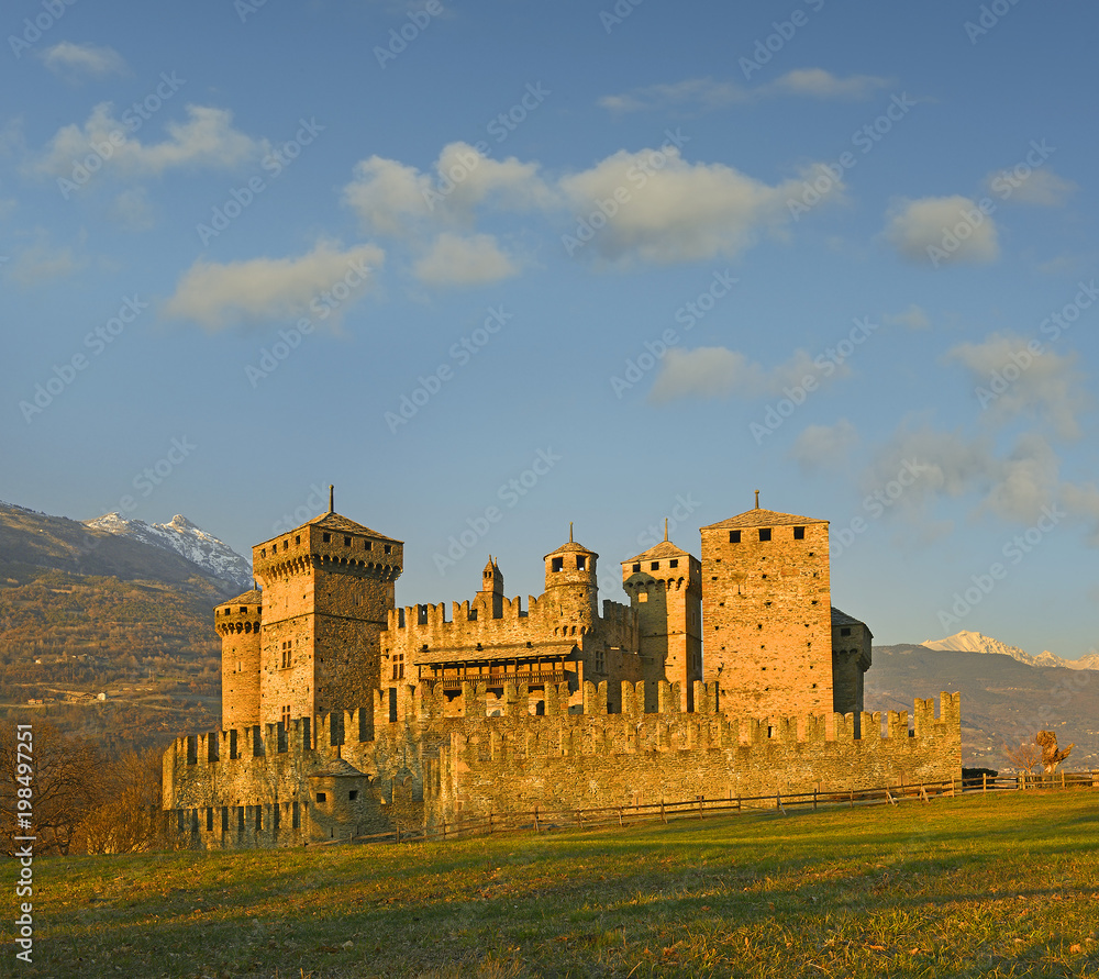 Fenis Castle in Aosta Valley at sunset. Fenis Castle is one of the ...