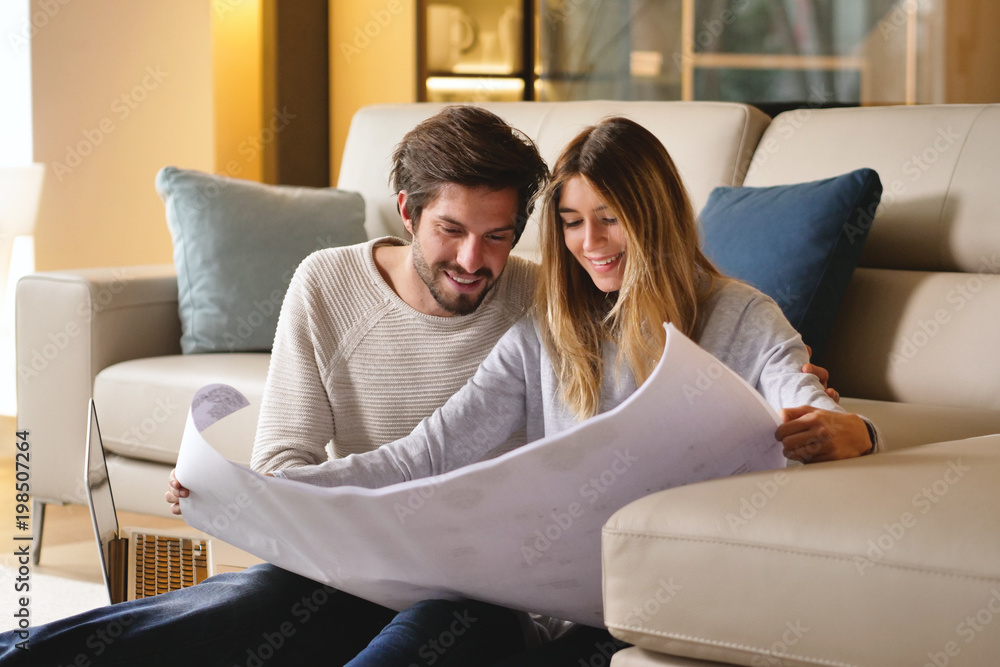 Portrait of a couple in love who is planning new home and furniture ...