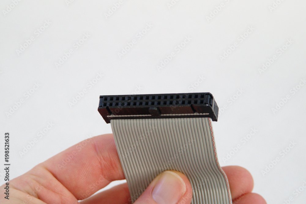 Hand holding IDE Connector and flat-ribbon cable, (IDE, Integrated ...