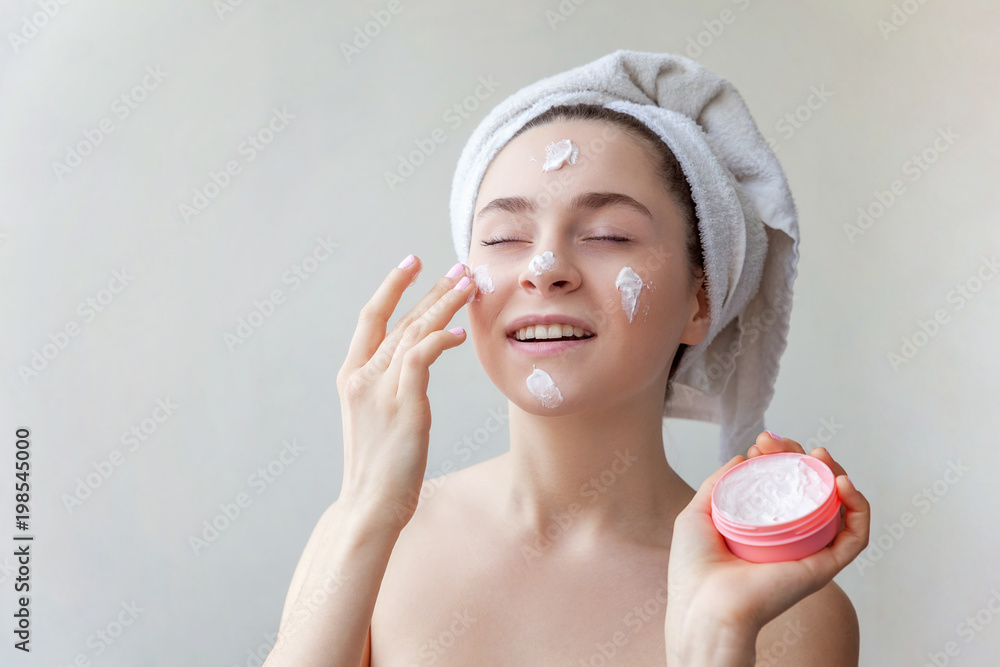 Beauty portrait of a smiling brunette woman in a towel on the head ...