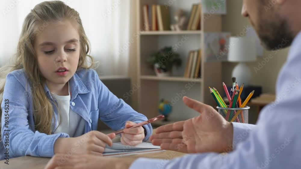 School girl arguing with father while doing homework, puberty age ...