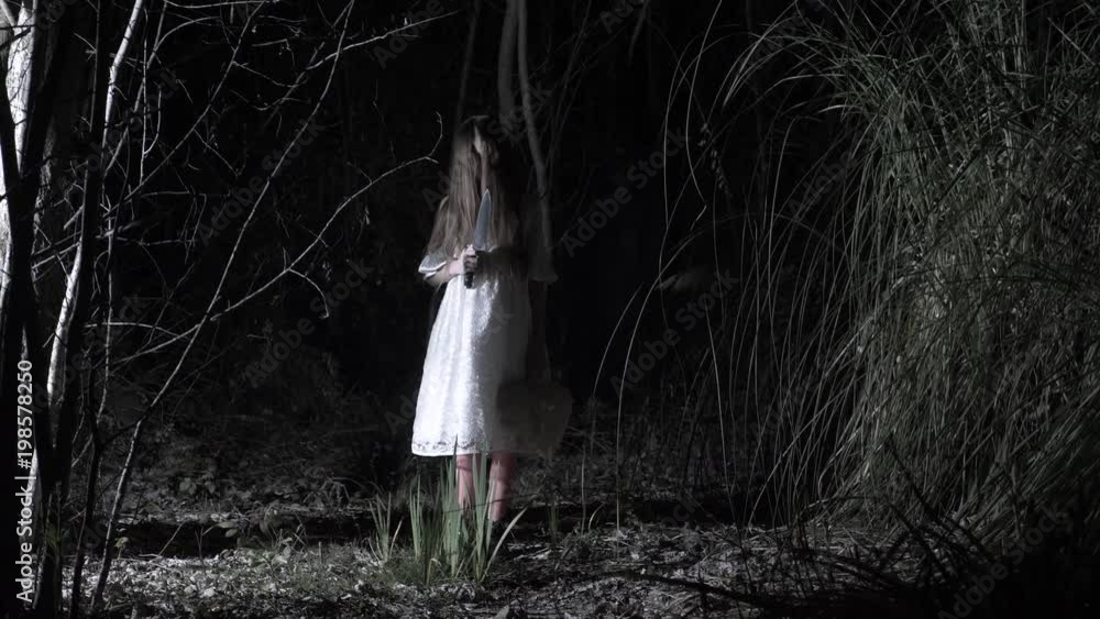 A little ghost girl with long black hair, in white, wandering through ...