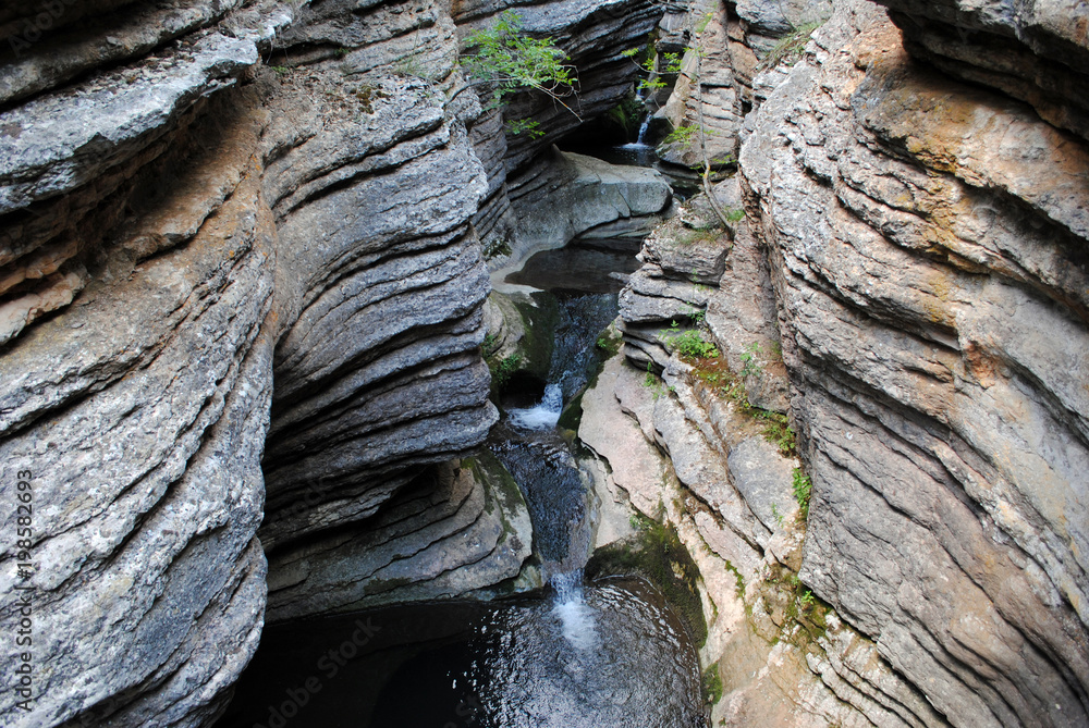 Mountain stream and geological layers of a sediment rocks canyon Stock ...