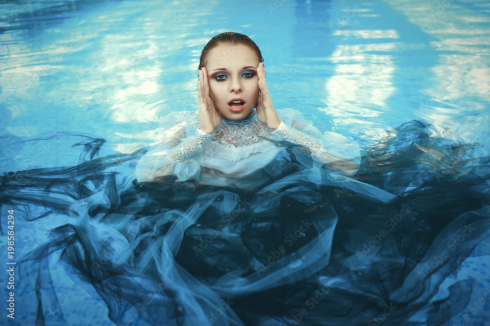 Beautiful model is posing in a swimming pool Stock Photo | Adobe Stock