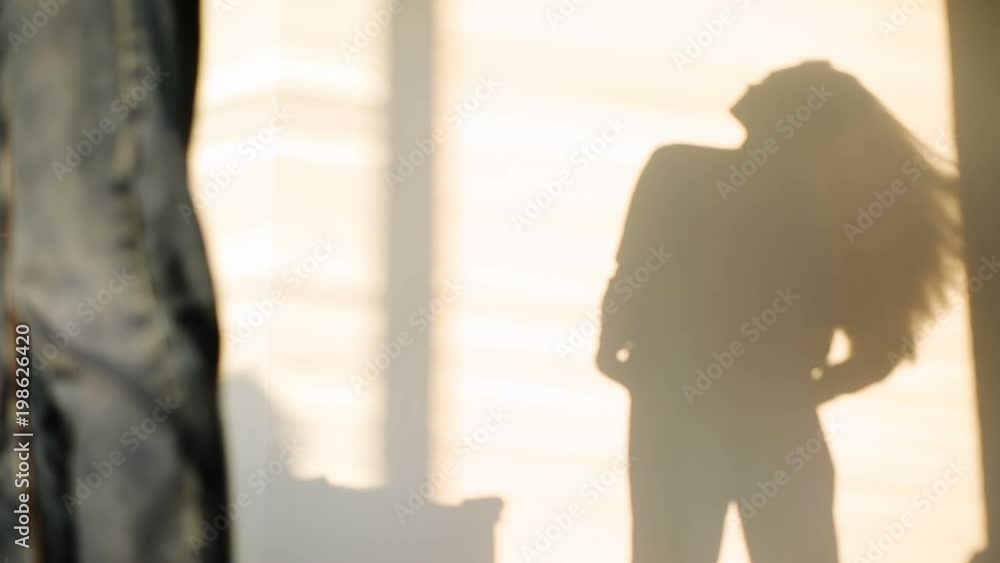 shadow on the wall inside of girl moving with flying hair silhouette ...