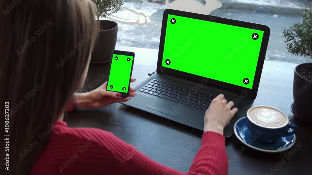The Girl in the Cafe Works With Gadgets With Green Screens. Girl ...