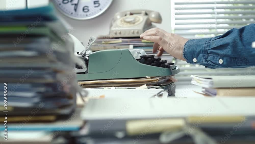 Employee typing with a typewriter and piles of paperwork Stock ビデオ ...