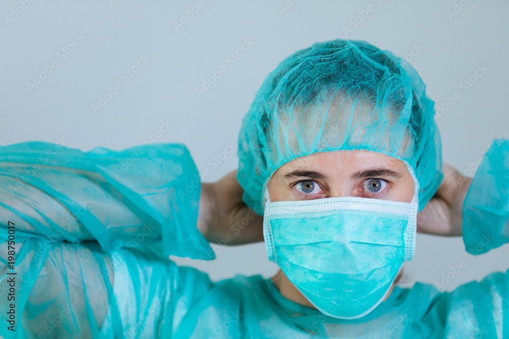 Young woman doctor with blue eyes wearing a cap and face mask Stock ...