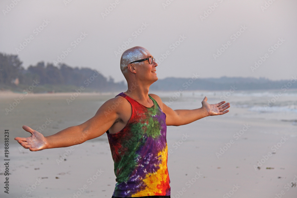 Bald man freak in bright clothes and round glasses at a freak parade or ...