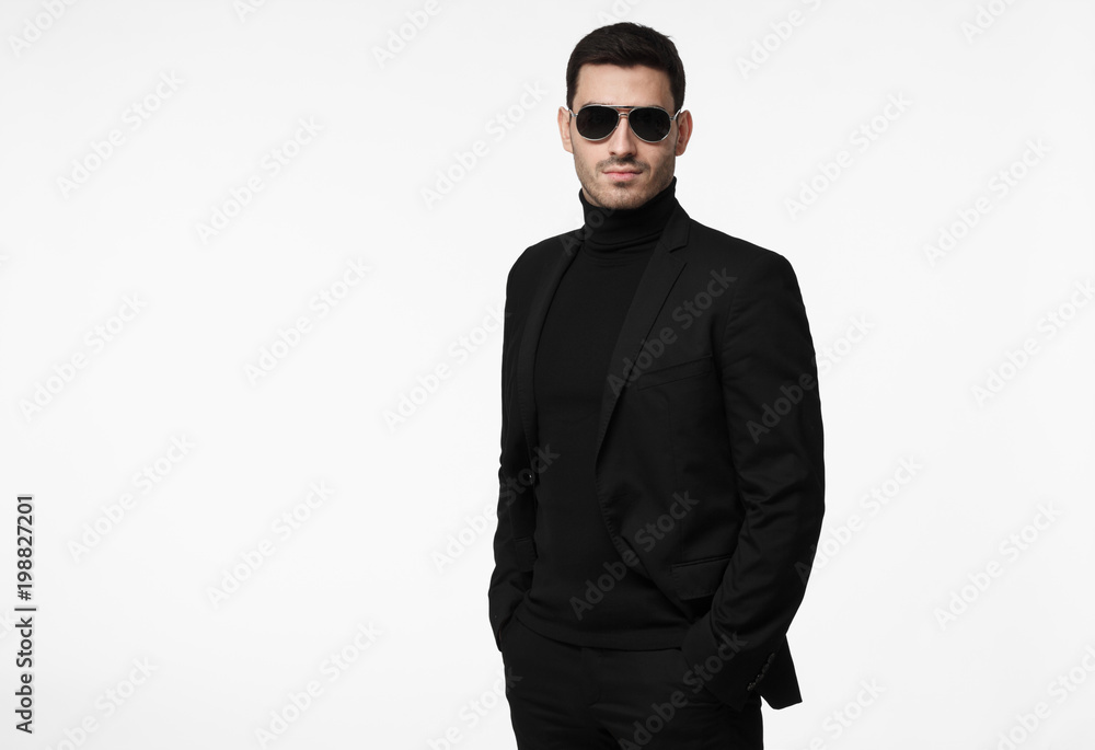 Serious body guard or secret agent wearing suit and sunglasses ...