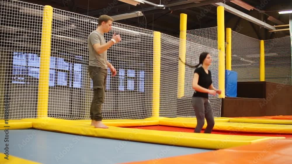 the sports man trains his podgoo with jumping on trampolines, the lady ...