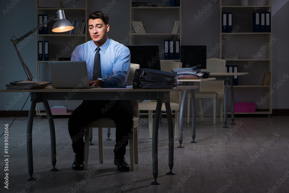 Employee working late at night at important report Stock Photo | Adobe ...