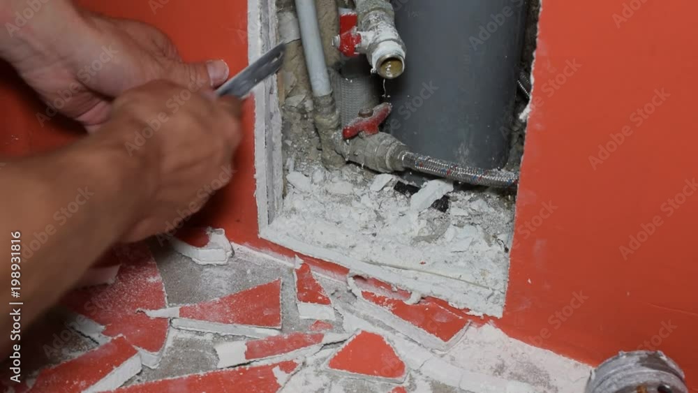 Stockvideon Hands of a craftsman making an inspection opening in ...