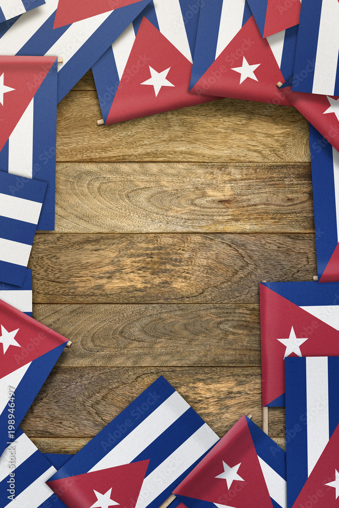 Cuba small flags framing a wood texture background with copy space ...