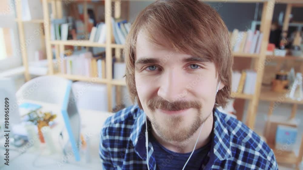 Nice kind man with a beard, blue eyes and a blue checked shirt looks ...