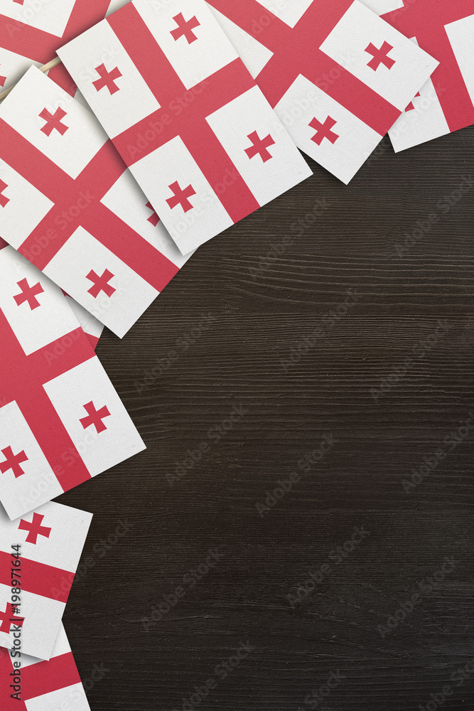 Georgia small flags framing a wood texture background with copy space ...