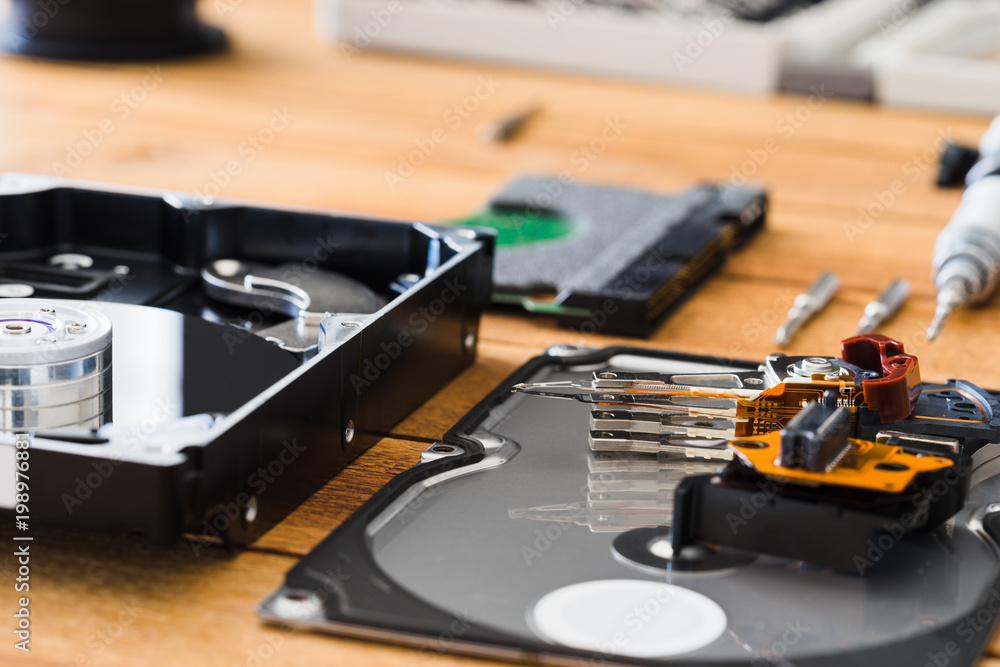 Disassembled hard disk drive inside close-up, spindle, actuator arm ...
