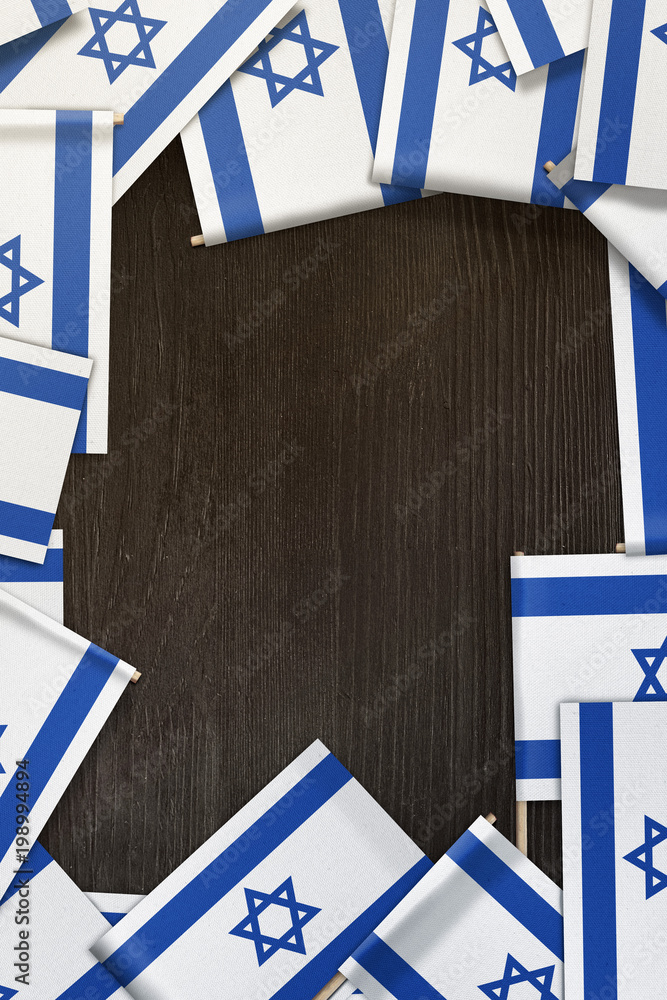 small Israel flags framing a wood texture background with copy space ...