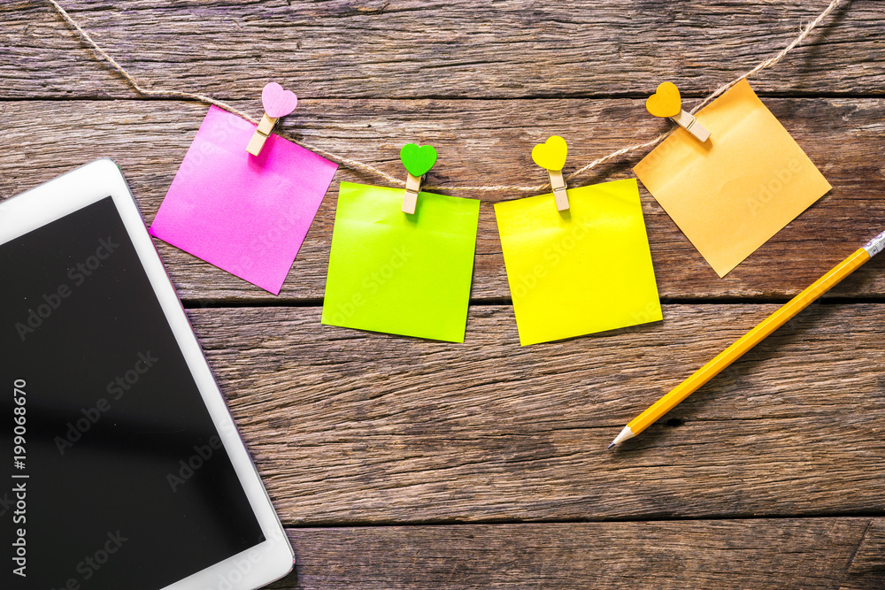 Note pad,sticky note with space for text. Placed on an old wooden floor ...