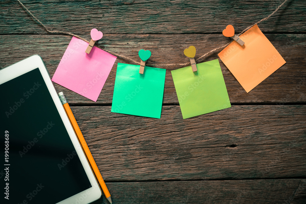 Note pad,sticky note with space for text. Placed on an old wooden floor ...