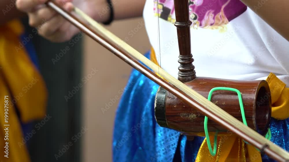 Thai children are playing Thai musical instruments, string instruments ...
