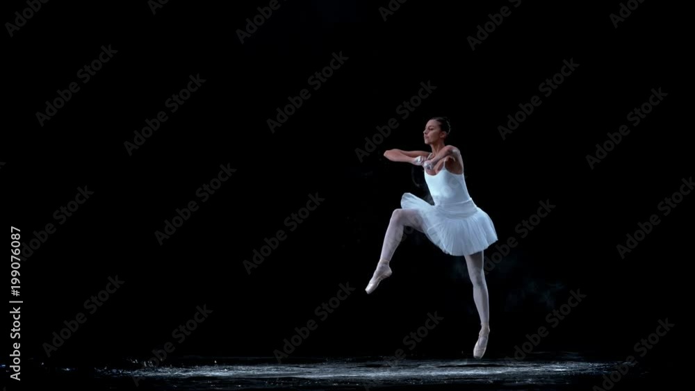 Ballerina performing on black background spinning slow motion Stock ...
