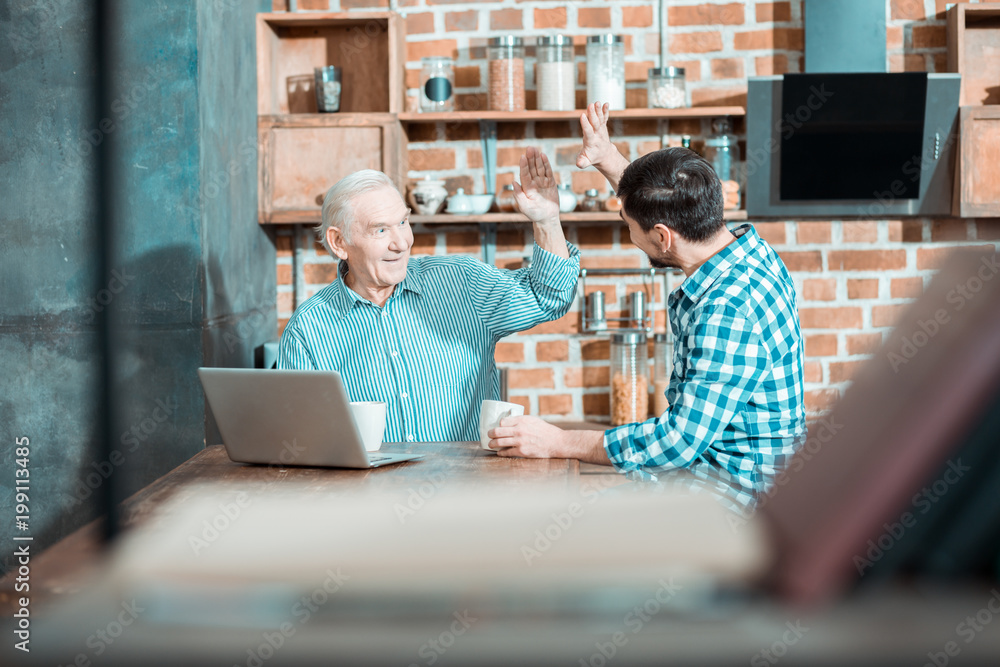 Nice positive father and son giving high five Stock Photo | Adobe Stock