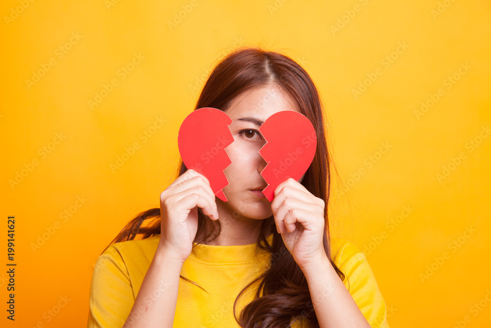 Beautiful young Asian woman with broken heart. Stock Photo | Adobe Stock