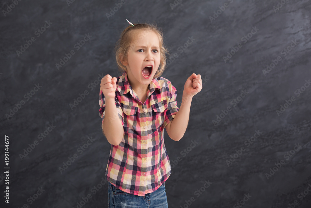 Angry little girl crying at gray background Stock Photo | Adobe Stock