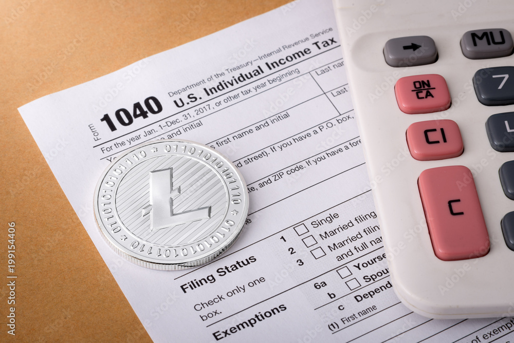 Litecoin physical silver coin symbol on 1040 tax form with calculator ...