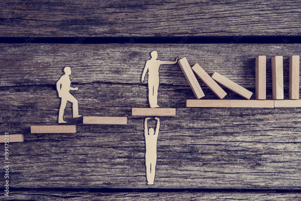 Retro toned image of silhouettes of a paper men helping each other with ...